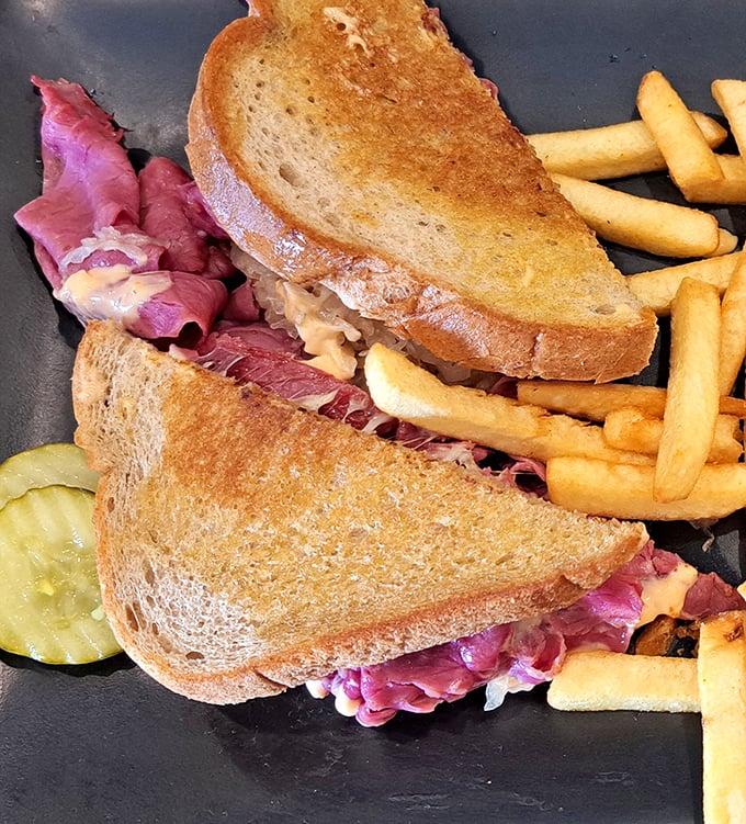 The Reuben sandwich—where corned beef, sauerkraut, and melted cheese create a symphony that makes you forget you're sitting in Kissimmee, not Manhattan.