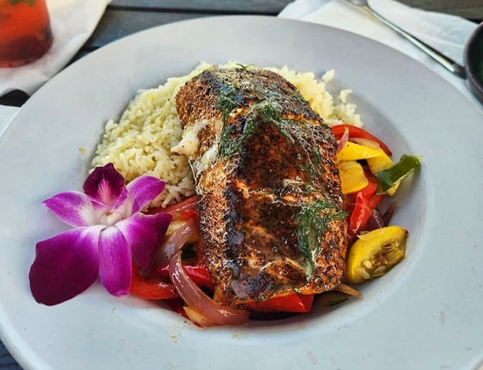 Blackened salmon that wears its spices like a well-tailored suit, resting on a bed of rice that's clearly been taking notes from the Caribbean.