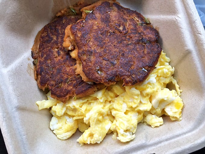 These aren't just sausage patties – they're edible hockey pucks of happiness, seasoned to perfection and nestled beside fluffy scrambled eggs.