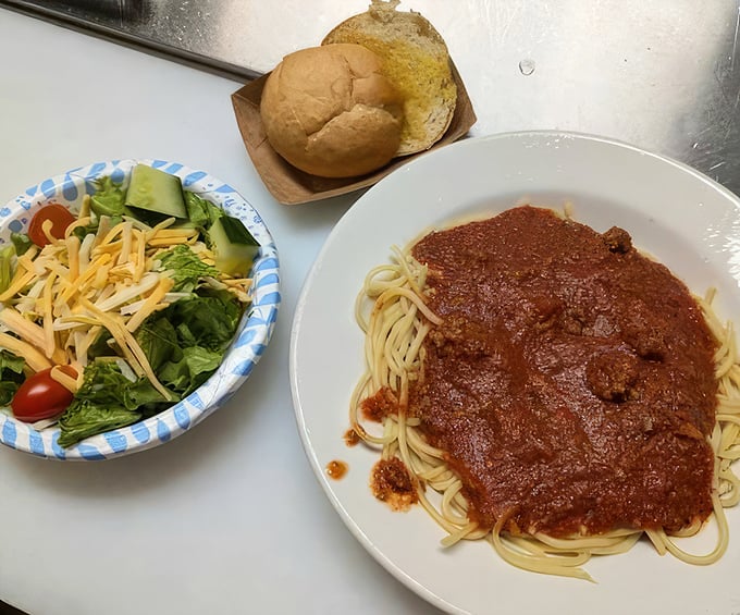Spaghetti with meat sauce—the universal language of comfort. This plate whispers, "You could make this at home, but why would you when it tastes better here?"