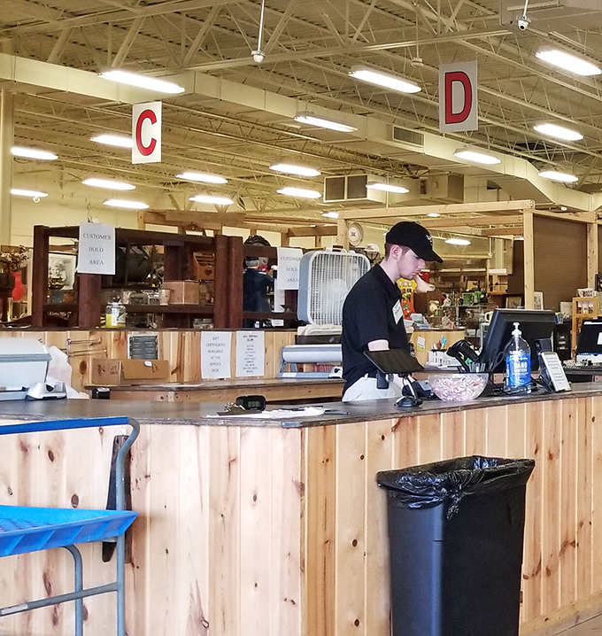 The command center where deals are sealed and treasures are tallied. Those hanging letters aren't just navigation aids—they're your alphabet to antiquing success.