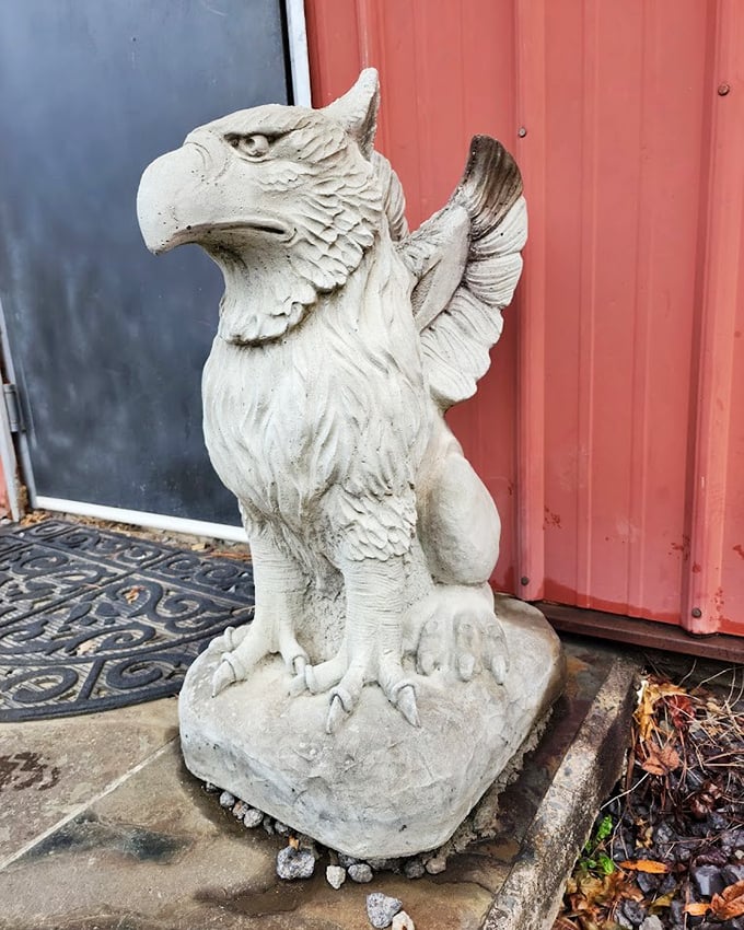 Not all guardians are flesh and blood—this stone griffin has watched over countless visitors, silently judging their antiquing skills.