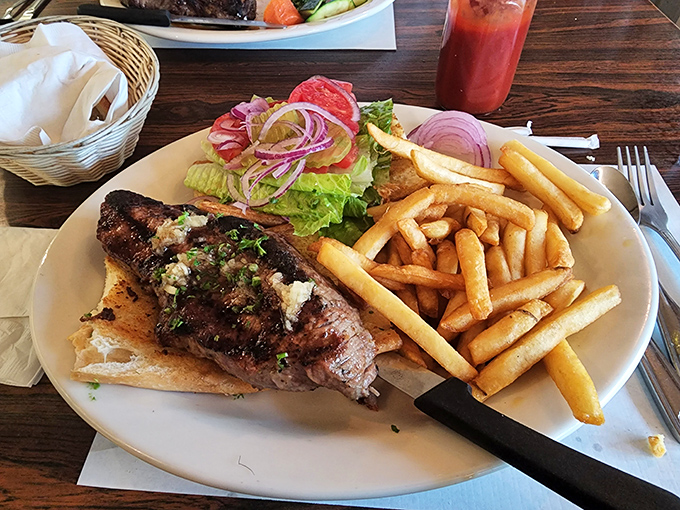 The legendary steak sandwich in all its glory—perfectly grilled beef on toasted bread with crispy fries and fresh garnish. Worth the drive from anywhere in California.