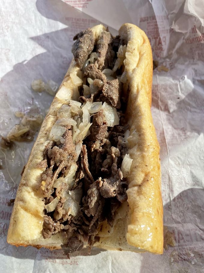 Simplicity perfected: thinly sliced beef and sweet onions nestled in that distinctive roll—the foundation of Pat's enduring legacy.