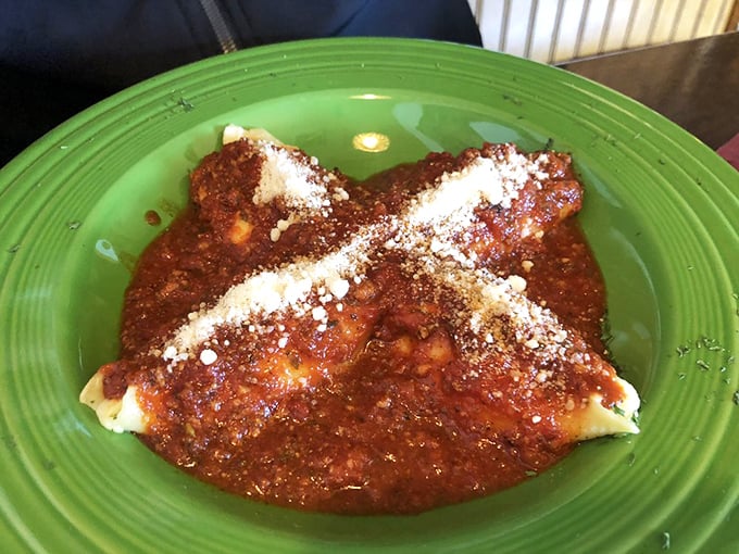 Stuffed peppers that look like they're auditioning for a food magazine cover—vibrant green shells cradling a savory filling under a blanket of marinara.