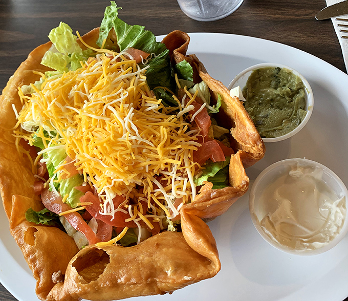 A taco salad that refuses to be a boring health food – that fried shell is basically saying, "Yes, there's lettuce, but we're still having fun here."