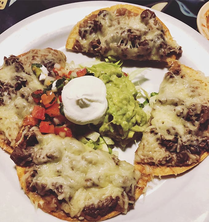 Simple pleasures done right—crispy tostada, fresh lettuce, and beans that clearly weren't rushed out of a can.