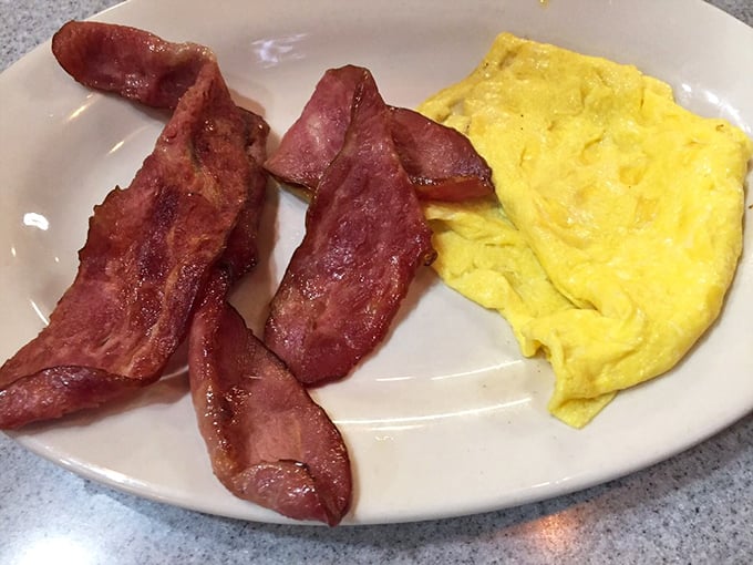 Breakfast simplicity at its finest—crispy bacon alongside fluffy scrambled eggs that somehow taste better than the ones you make at home.