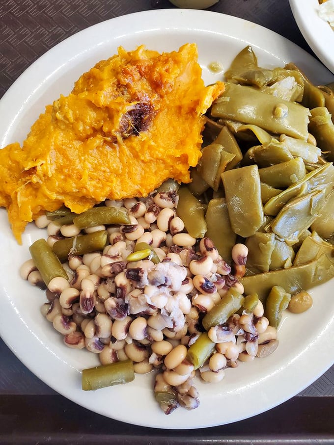 A Southern vegetable plate that would make any grandmother proud—sweet potato soufflé, black-eyed peas, and green beans that never saw the inside of a can.