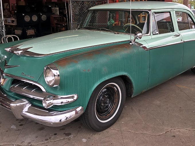 This mint-green vintage beauty isn't just a car—it's automotive poetry from an era when dashboards gleamed and tail fins reigned supreme.