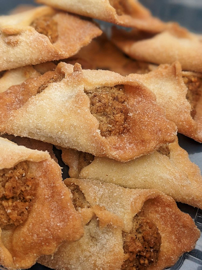 These walnut cookies aren't just dessert—they're little envelopes of sweetness with corners crimped by hand, waiting to deliver their nutty message.