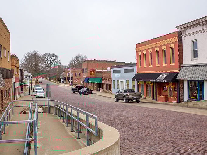 Colorful storefronts and brick streets create a charming atmosphere where neighbors still wave at strangers.