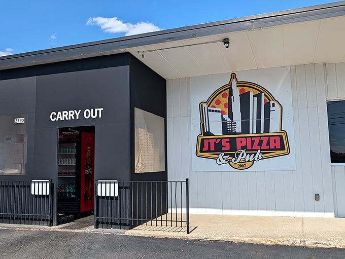 JT's modern black and white exterior houses serious pizza credentials. The "CARRY OUT" sign promises deliciousness to enjoy anywhere.