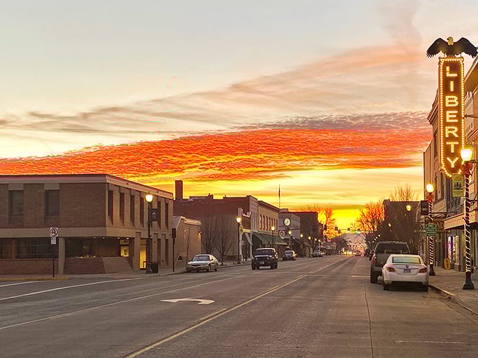 A quiet street in La Grande basks in the glow of a sunset sky, with the Liberty Theatre sign standing proud as a beacon of the town’s enduring charm.
