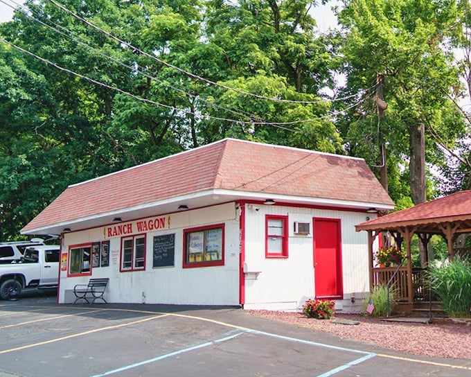 White clapboard with red trim—a hot dog cottage in a parking lot. This roadside gem proves good things come in small, unassuming packages.
