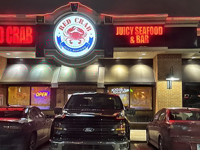 Red Crab's neon glow cuts through the night like a lighthouse for the hungry. Those cars aren't just parked—they're waiting for seafood magic.