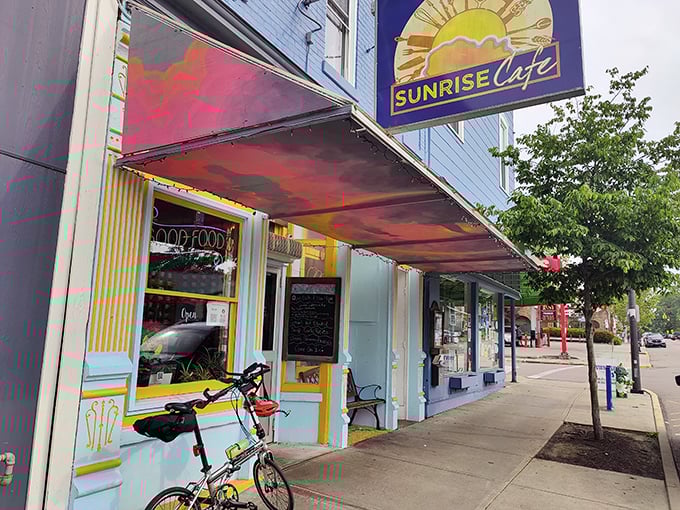 That sunshine-yellow awning radiates pure joy, promising mornings as bright as the café's cheerful spirit.
