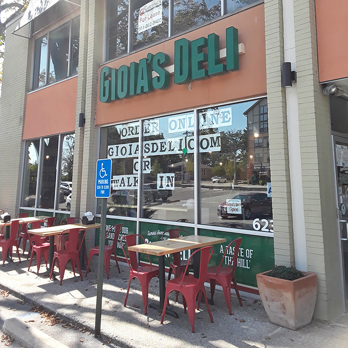 Red chairs on patios invite you to slow down and savor every bite of sandwich perfection.