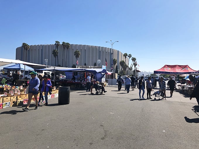 The Forum looms majestically while bargain hunters create their own entertainment in the parking lot below.