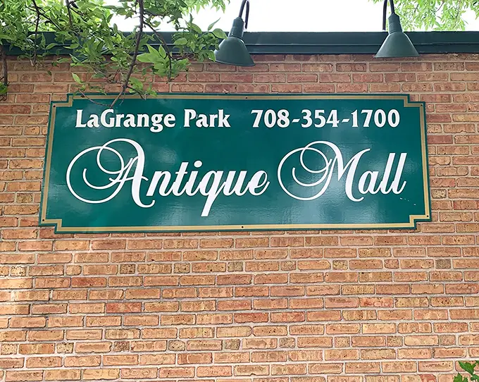 That simple green sign doesn't need to shout—the treasures inside this brick building do all the talking.
