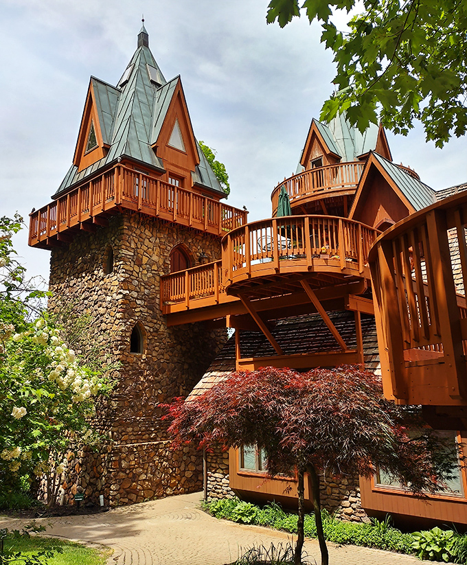Multi-level castle magic nestles in treetops, where medieval meets modern in perfect woodland harmony.