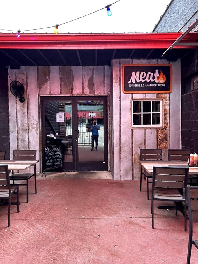 Colorful outdoor seating and string lights create the perfect backdrop for enjoying seriously good smoked meats with friends.