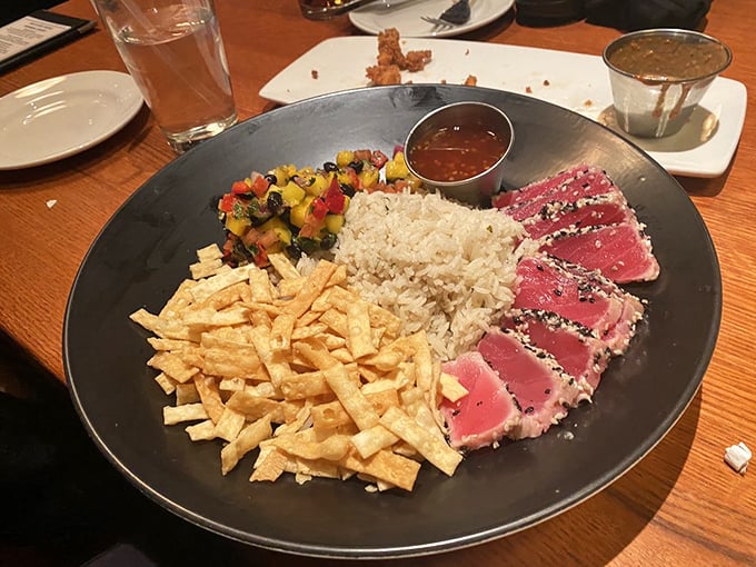 Sesame-crusted ahi tuna, perfectly rare and artfully presented. This dish makes you wonder why you ever settled for lesser proteins. 