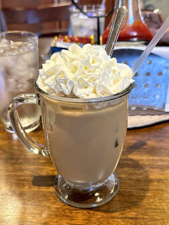 This isn't just coffee, it's an Amaretto Latte wearing a cloud of whipped cream—dessert masquerading as a beverage, and we're not complaining.
