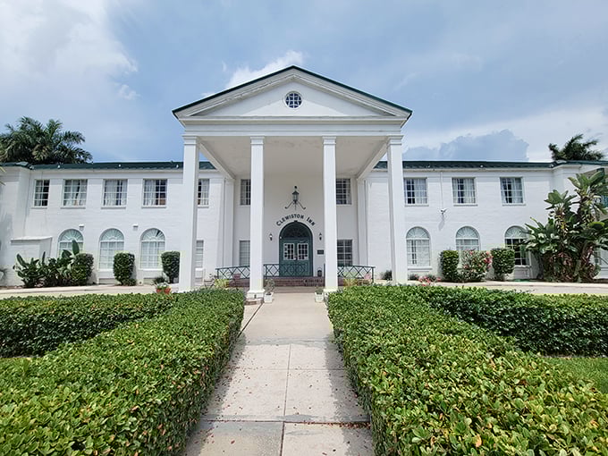 The Clewiston Inn's stately white columns welcome visitors like a Southern belle greeting guests at a garden party – gracious, elegant, and timeless. 
