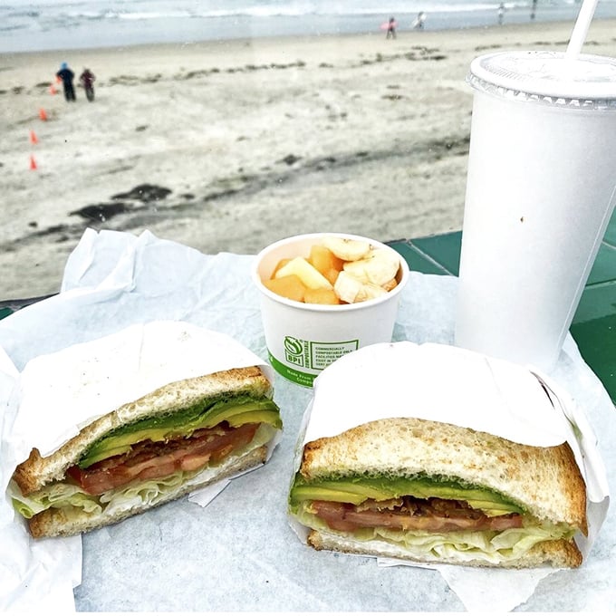 The BLT elevated to art form with avocado, served oceanside—because sandwiches taste better when they come with a side of vitamin sea.