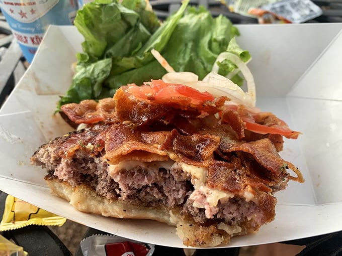 A burger so honest it should run for office – melted cheese cascading over a hand-formed patty with bacon that's achieved the perfect crisp-to-chewy ratio.