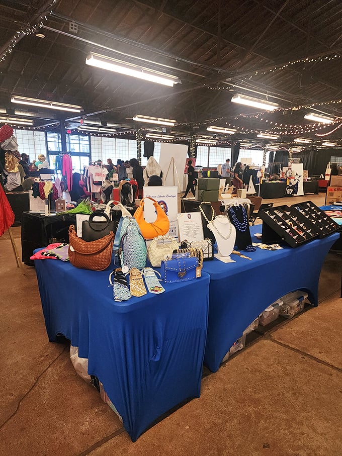 A blue-draped vendor table showcasing handbags and jewelry – retail therapy stations strategically positioned for maximum "I deserve this" justification.