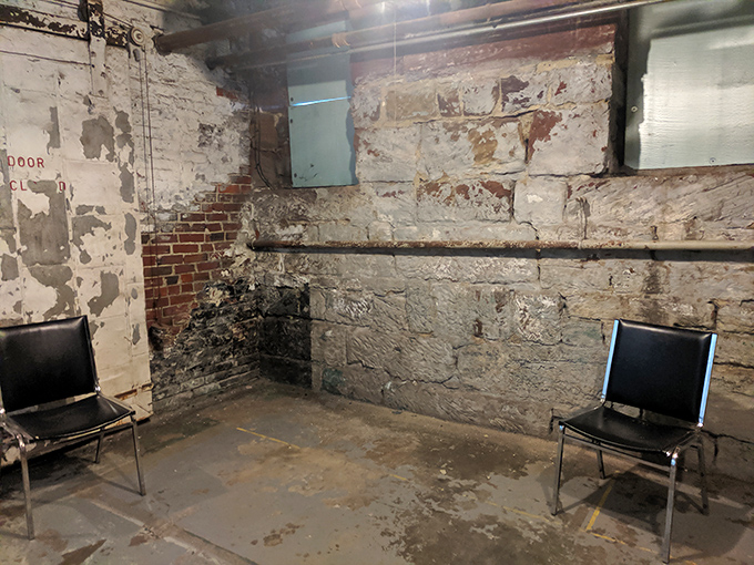 Basement accommodations at the jail make today's studio apartments look positively palatial. Two chairs facing a crumbling wall—the original timeout corner.