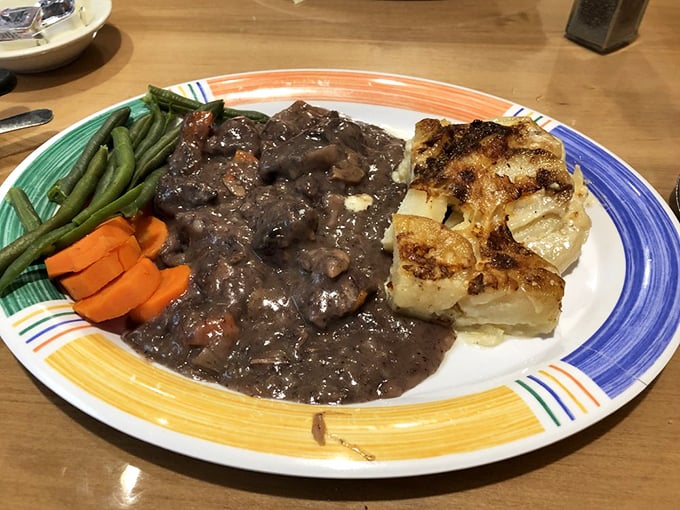 Beef tips in rich gravy alongside fresh vegetables and golden potatoes—proof that dinner at Country Boy isn't playing second fiddle to breakfast.