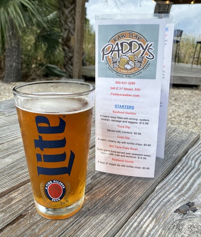 A cold Miller Lite in a proper glass with a menu of possibilities—sometimes the simplest pleasures make the best vacation companions.