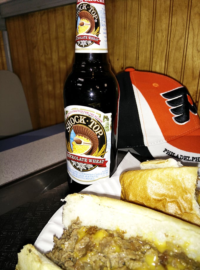 Nothing says "Philly sports fan fuel" like a local craft beer alongside a classic cheesesteak. The Flyers cap approves.