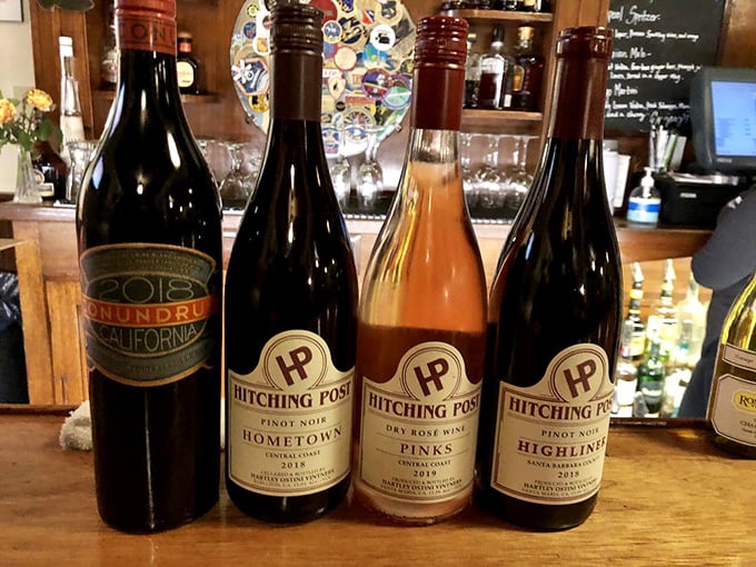 The Hitching Post's own wine lineup—because when you perfect steak, you might as well create the perfect pairing too. Liquid companions for your carnivorous adventure.