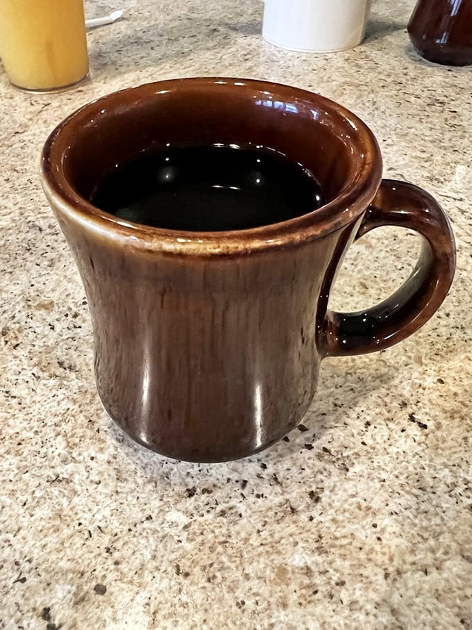 The sturdy brown mug says it all—this coffee means business. No fancy foam art needed when the brew itself delivers a perfect morning handshake.