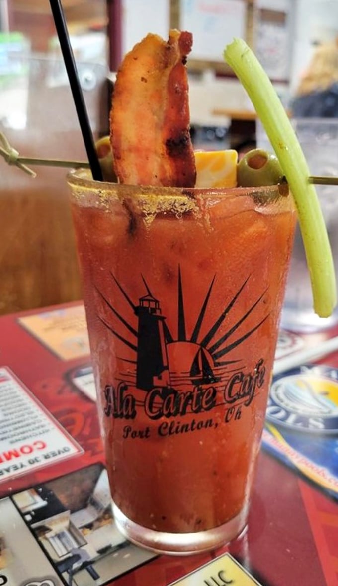 The Bloody Mary that eats like a meal. Complete with bacon, celery, and the café's lighthouse logo—because drinking should never be boring.