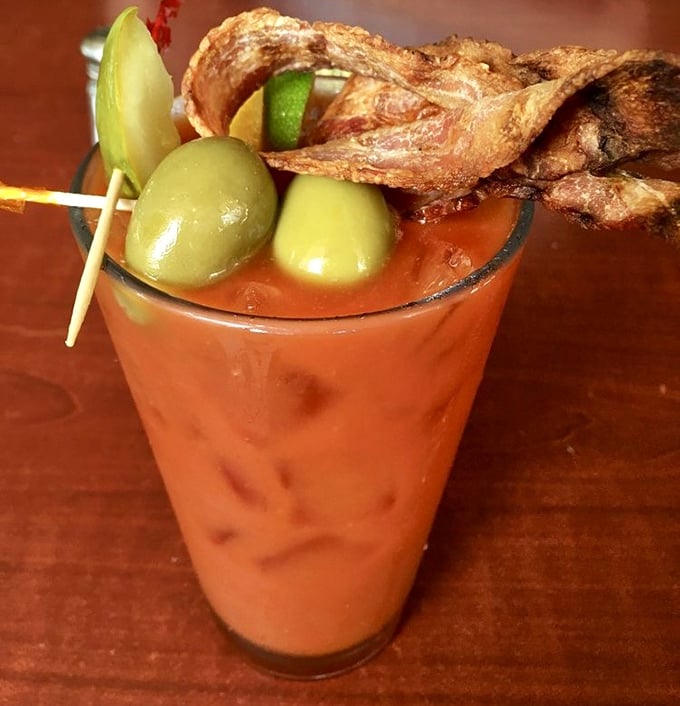 A Bloody Mary that's practically a meal unto itself, complete with olives, bacon, and what appears to be the kitchen sink. Brunch in a glass!