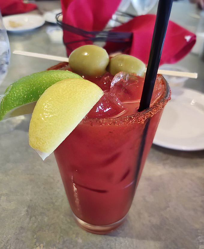 A Bloody Mary that's practically a meal unto itself. Those olives aren't garnish—they're lifeguards watching over a sea of spicy tomato goodness.