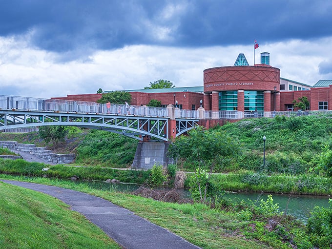 The Blount County Public Library isn't just about books—it's a modern community hub connected to nature by an architectural handshake across the water.