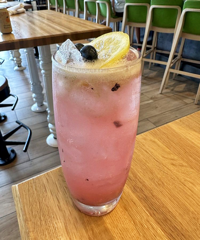 This blushing cocktail, garnished with fresh berries and citrus, isn't just Instagram-worthy—it's the sophisticated adult version of your childhood lemonade stand.
