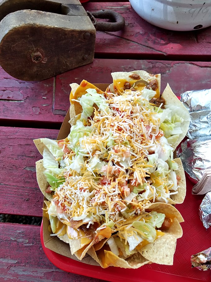 These nachos aren't just a side—they're a main event. Cheese, lettuce, and chips creating a symphony of crunch and gooey goodness.