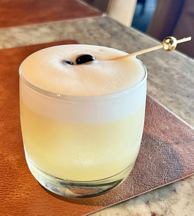 A cocktail that doesn't just look pretty—it tells a story. That foam cap isn't showing off; it's delivering layers of flavor with each sip.