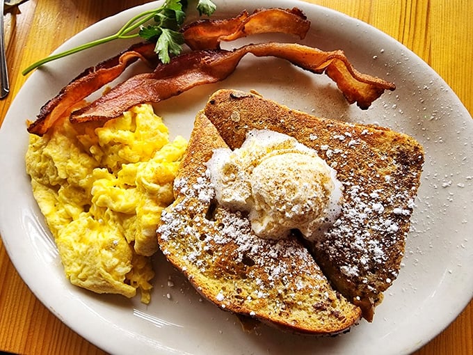 French toast with a cloud of whipped butter, scrambled eggs, and bacon—the breakfast trinity that's converted more morning skeptics than coffee.