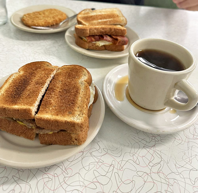 Breakfast sandwiches that laugh at your fancy avocado toast. Golden-grilled bread hugging eggs and meat—the morning fuel of champions.