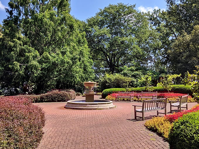 A brick plaza with thoughtfully placed benches invites visitors to sit awhile—because sometimes the best garden activity is simply doing nothing at all.