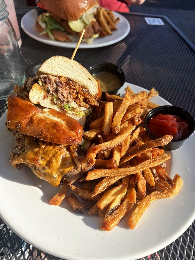 This brisket sandwich towers like a delicious monument to everything right about American comfort food done properly.