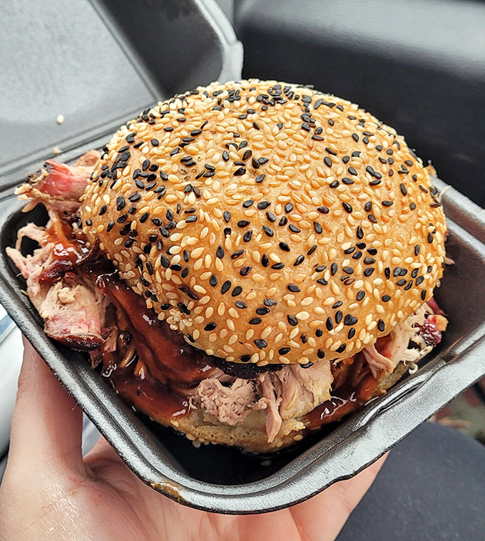 A sandwich that requires both hands and your full attention. That sesame-studded bun cradles its smoky treasure like it knows how lucky it is.